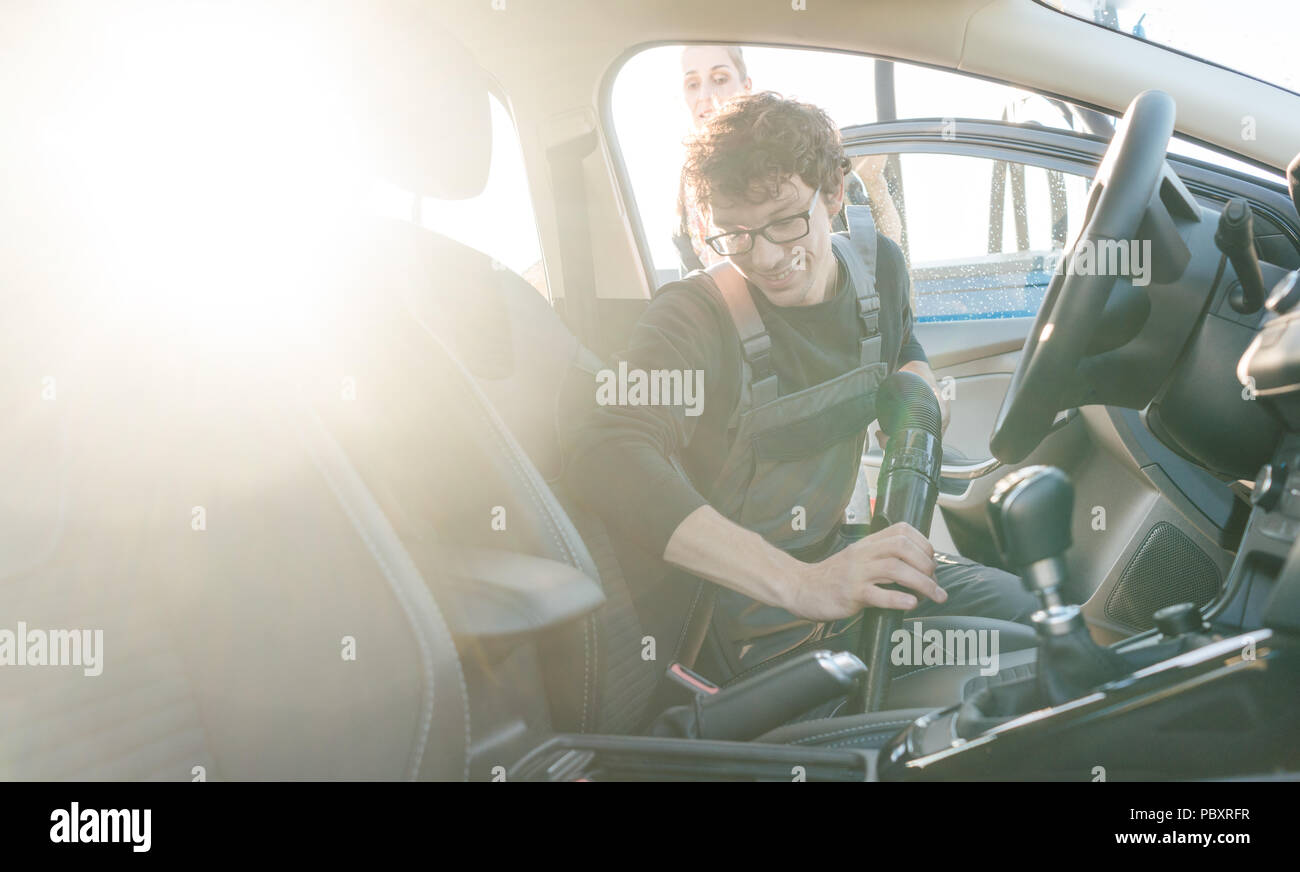 Car interior cleaning man vacuuming hi-res stock photography and images ...