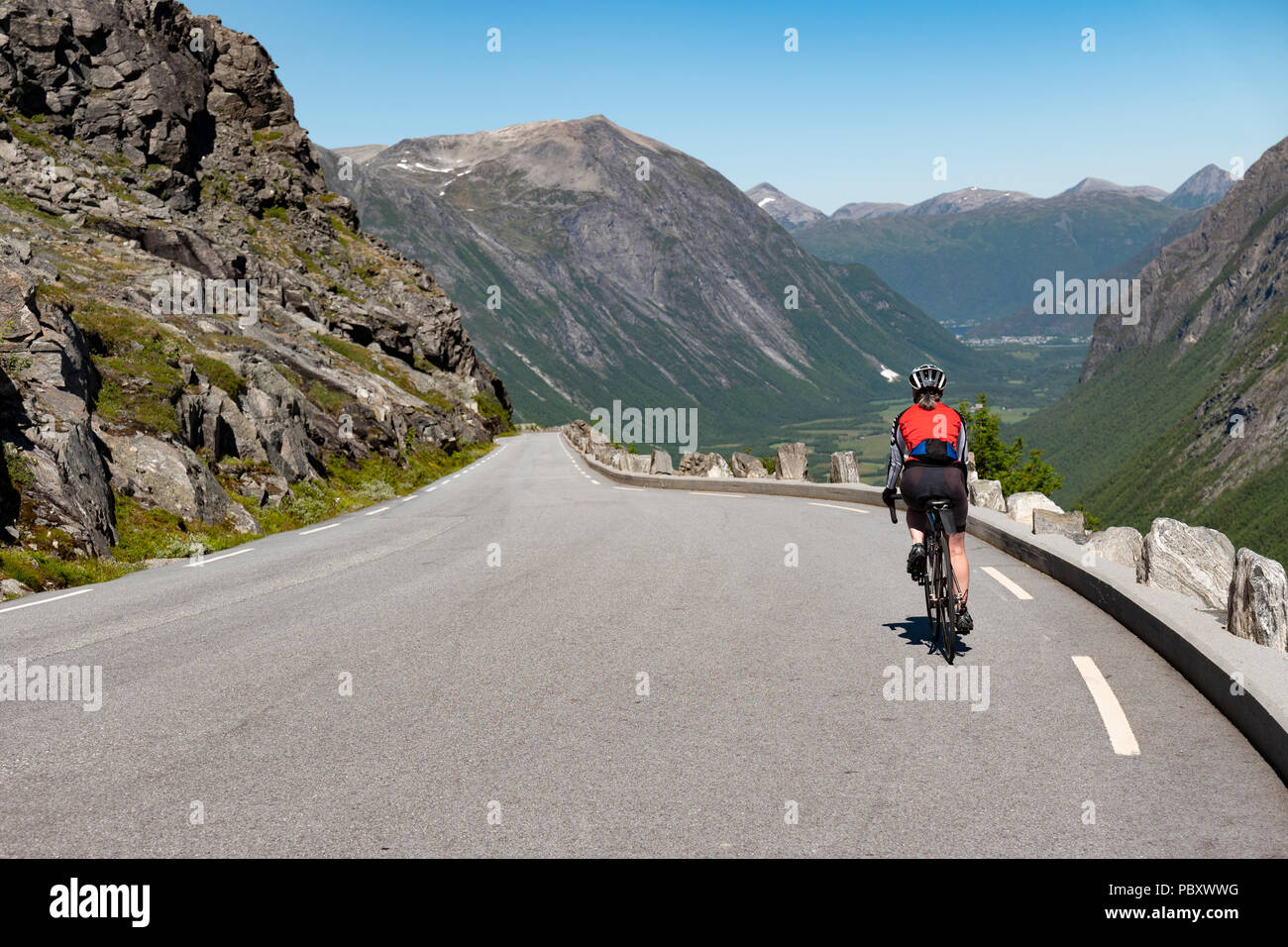 Female cyclist descending the famous Trollstigen pass, Norway Stock ...