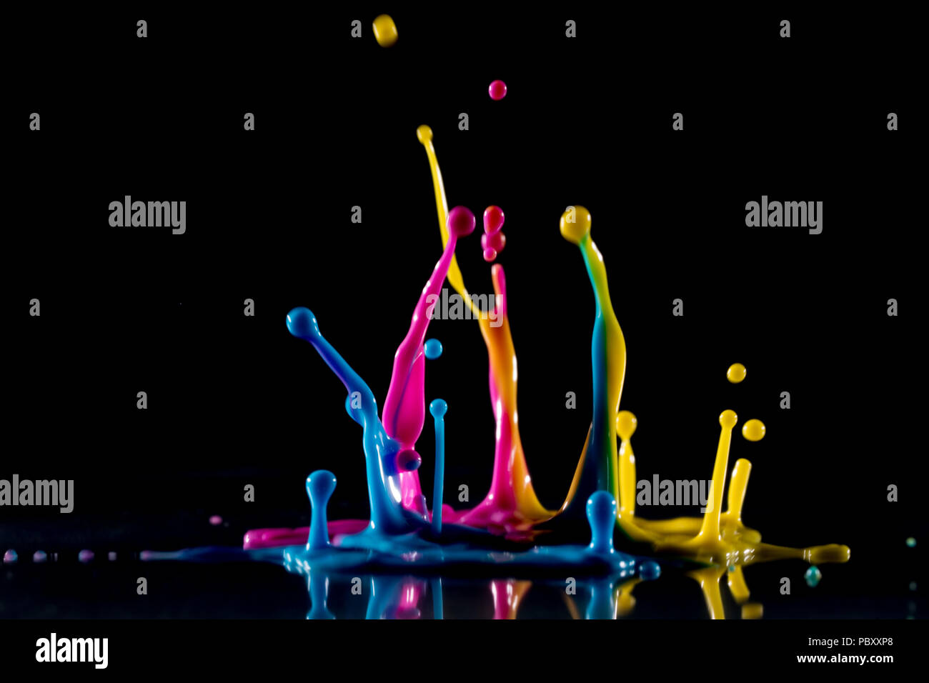 Abstract sculptures of colorful splashes of paint. Dancing liquid on a ...