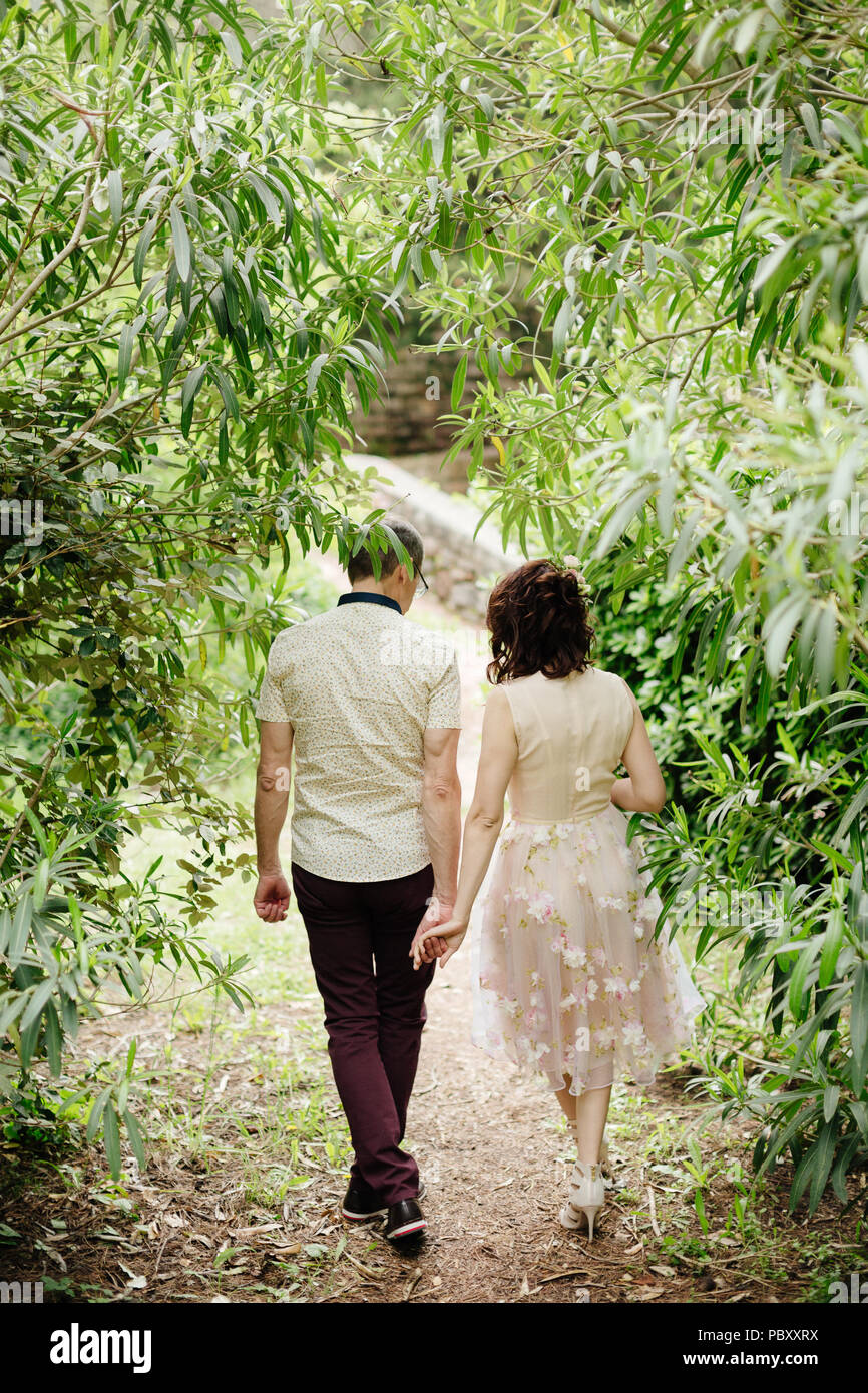 couple walking in forest in summer Stock Photo - Alamy
