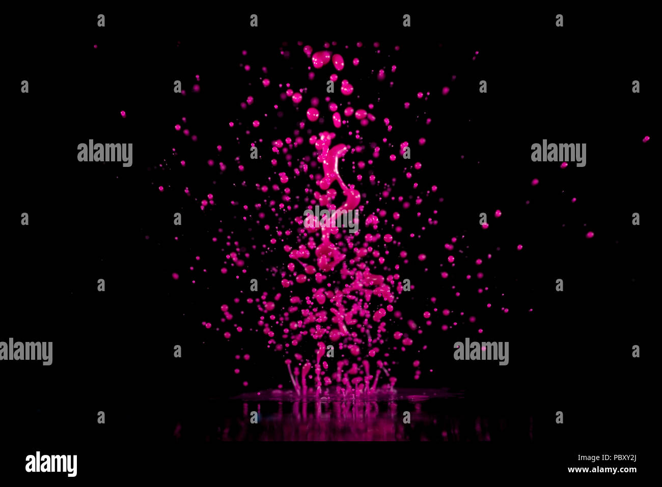 Magenta, pink paint, ink splash on black background Stock Photo - Alamy