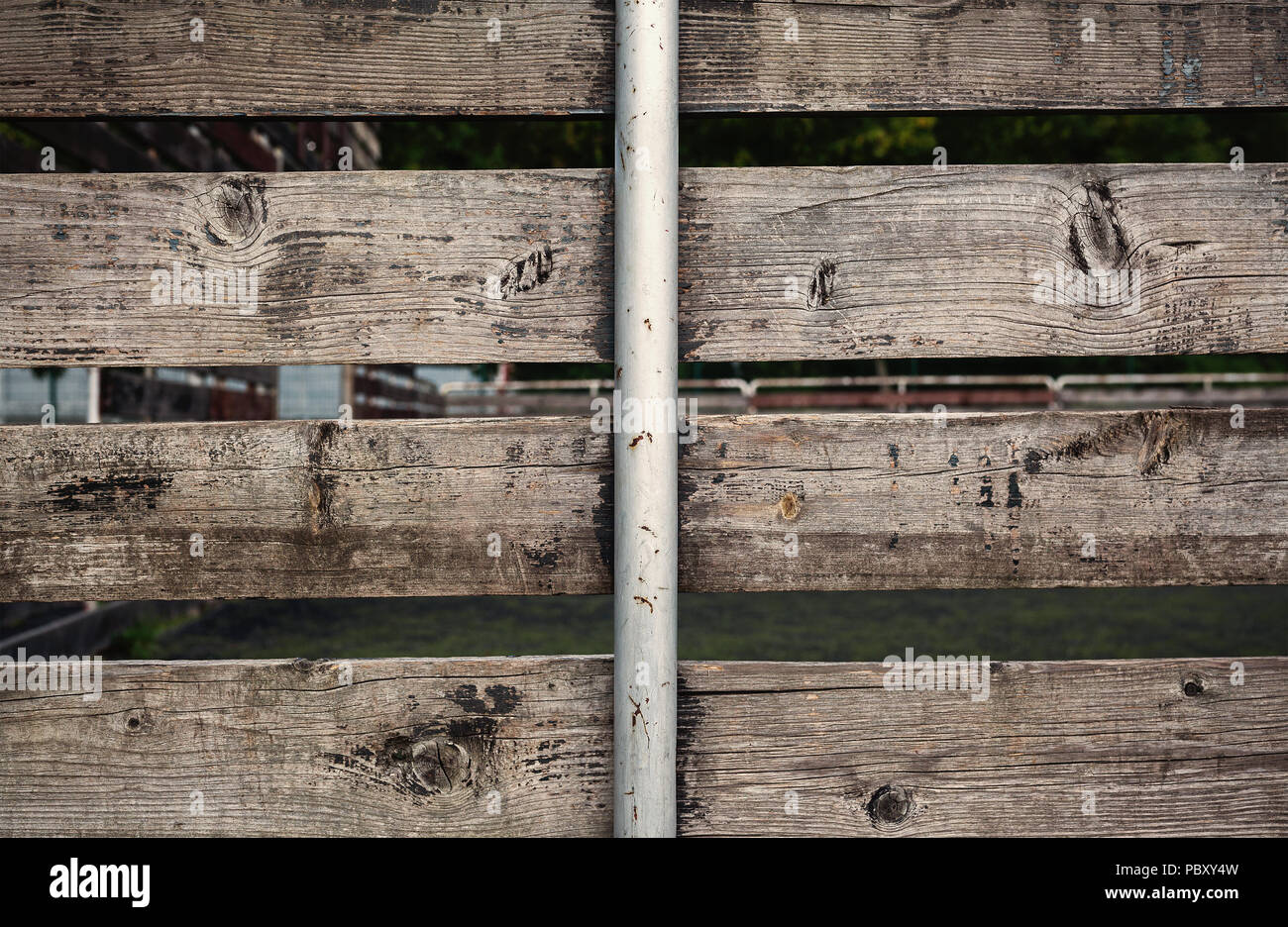 Details of an old wooden fence with one metal bar in the middle Stock ...