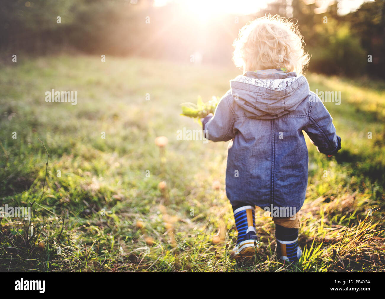 Boy walking outdoors hi-res stock photography and images - Alamy
