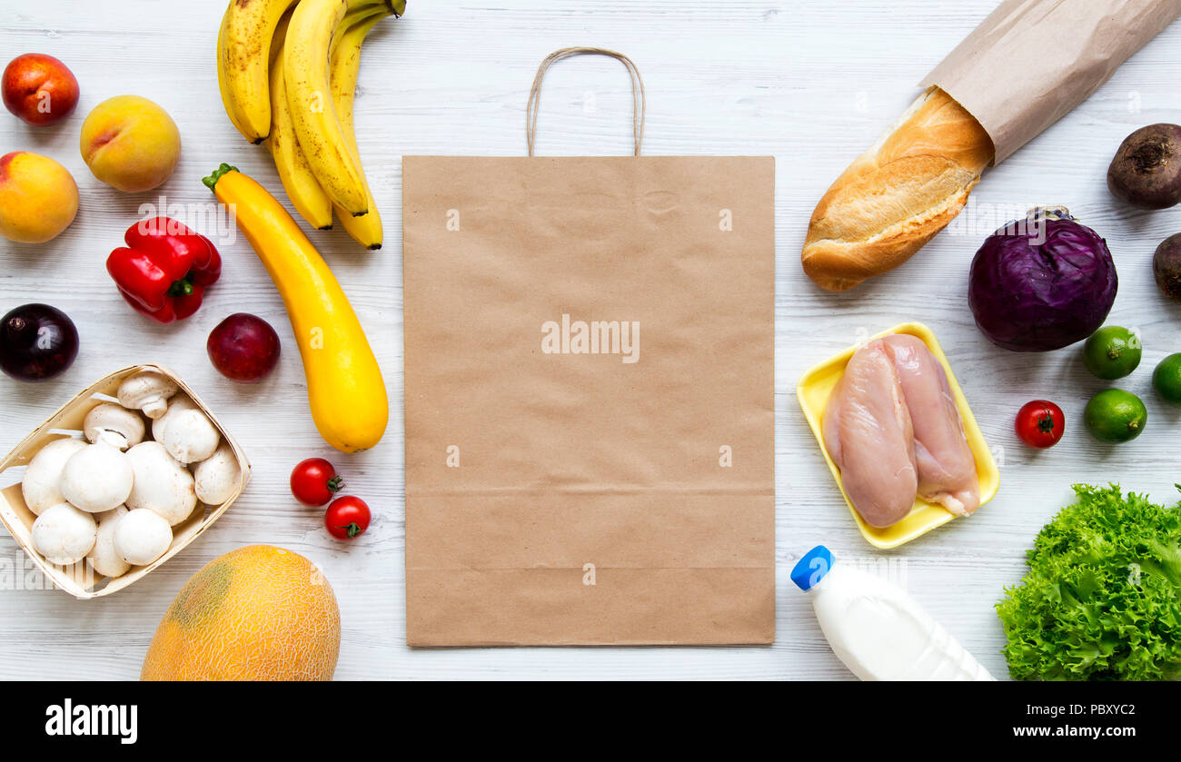 Healthy raw food with paper bag on white wooden table. Cooking food ...