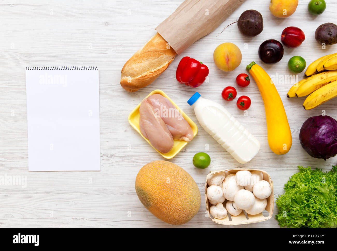 Set of variety fresh healthy food with paper for notes on white wooden ...