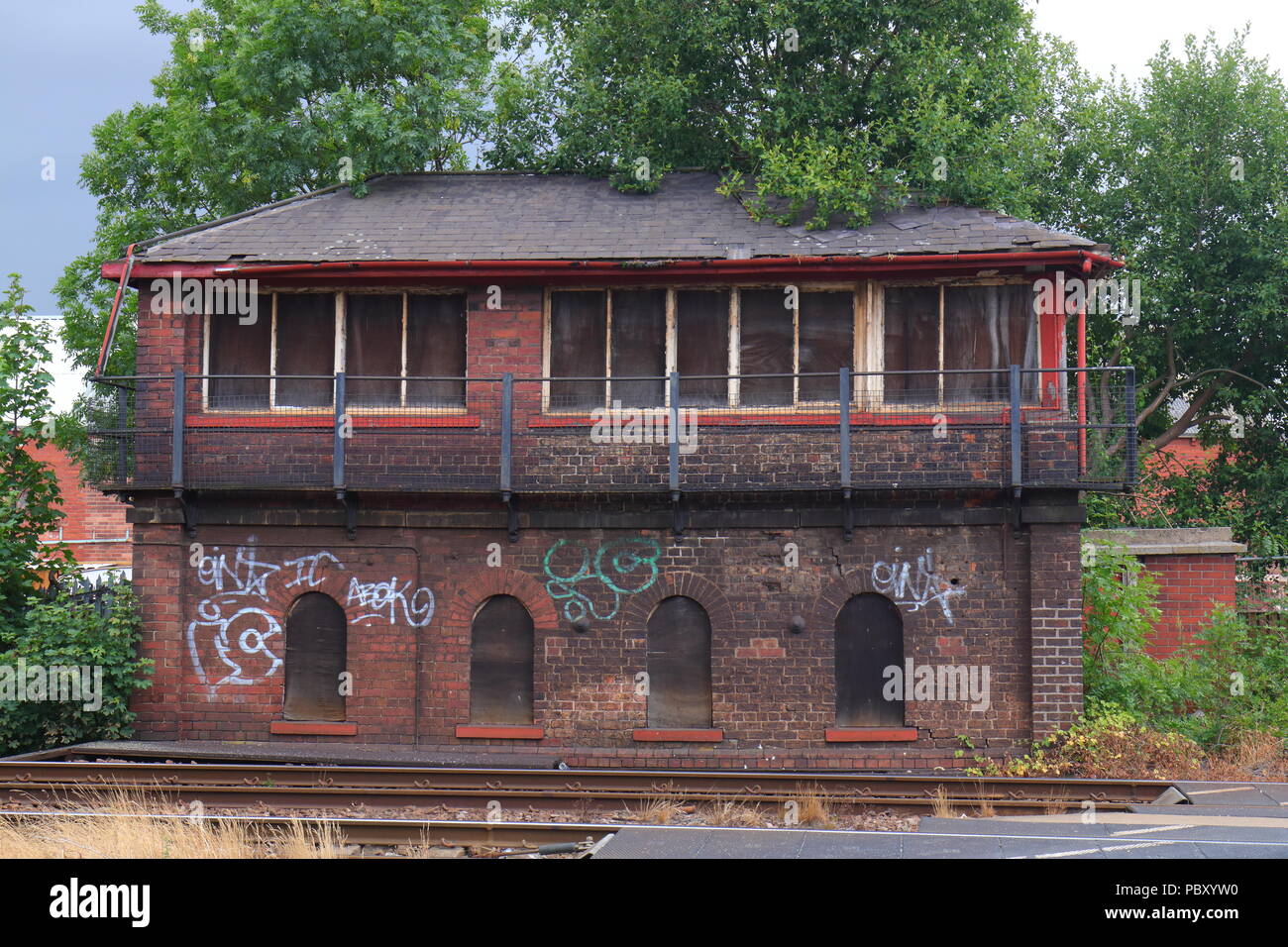 A disused railway signal box next to a level crossing in Castleford ...