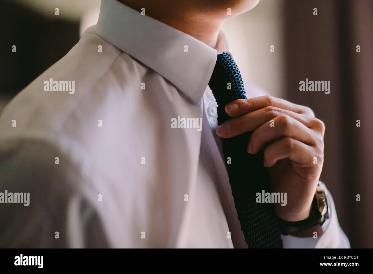 Young man businessman getting dressed for work hi-res stock photography ...