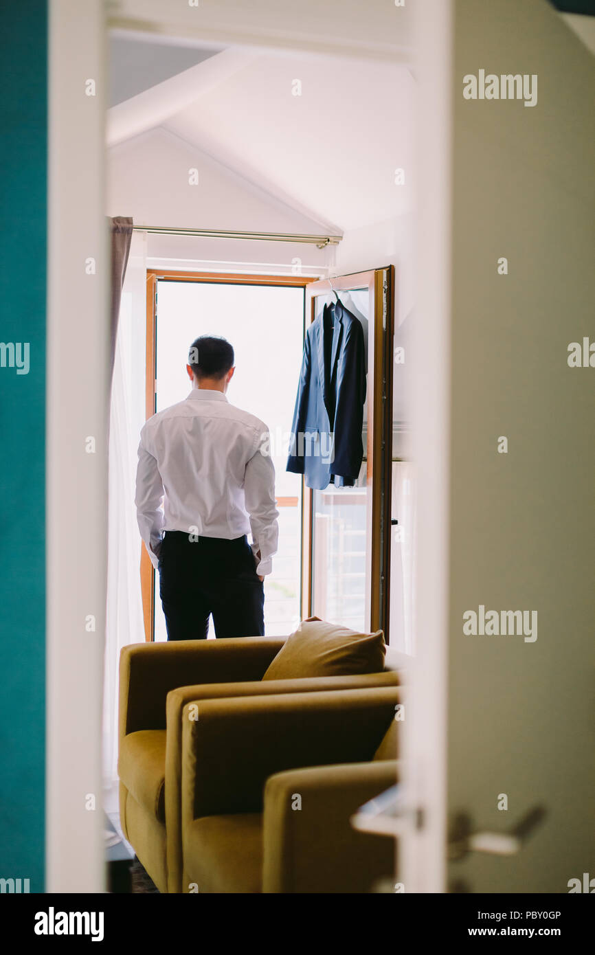 man getting dressed in hotel Stock Photo - Alamy