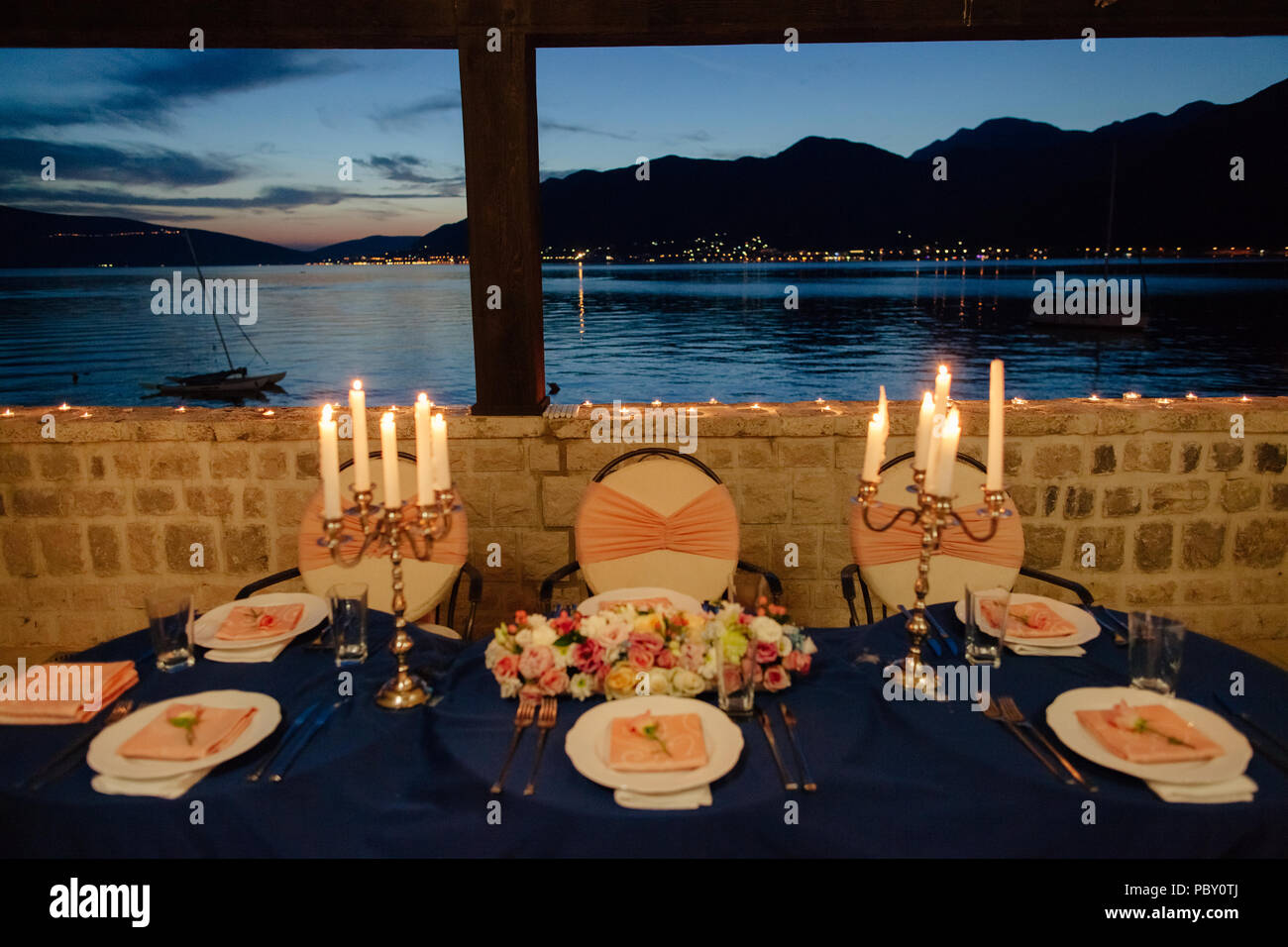 romantic table decoration with candles at sunset Stock Photo - Alamy