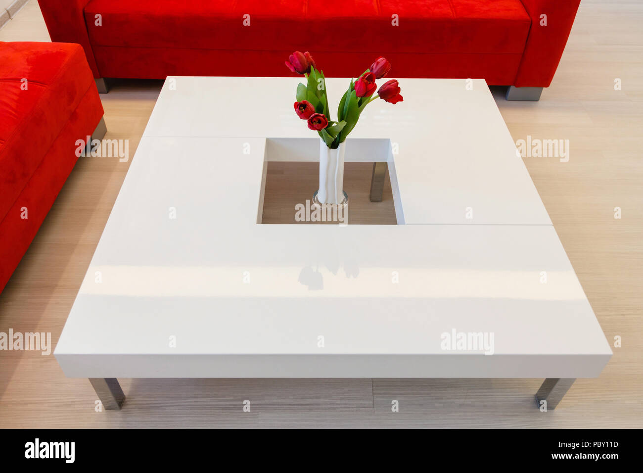 Modern table with red flowers Stock Photo - Alamy