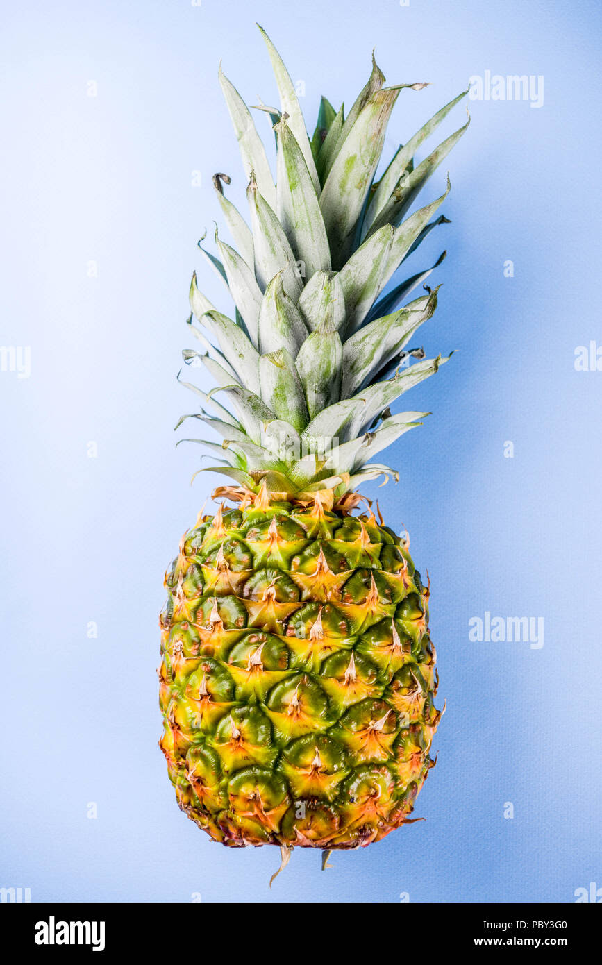 Fresh whole pineapple on bright blue yellow background copy space Stock ...