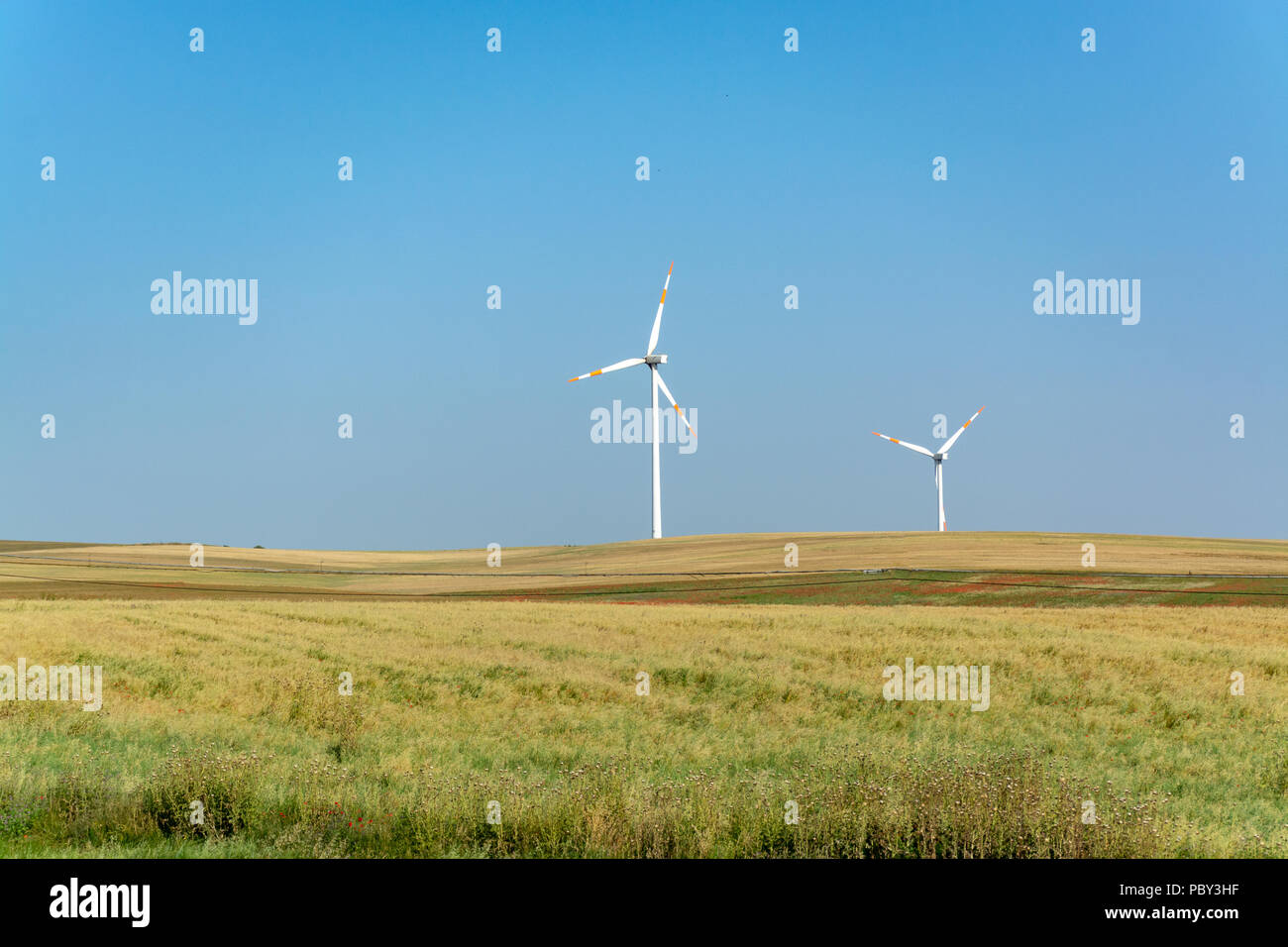 Modern wind farm with big wind turbines towers, source for renewable ...
