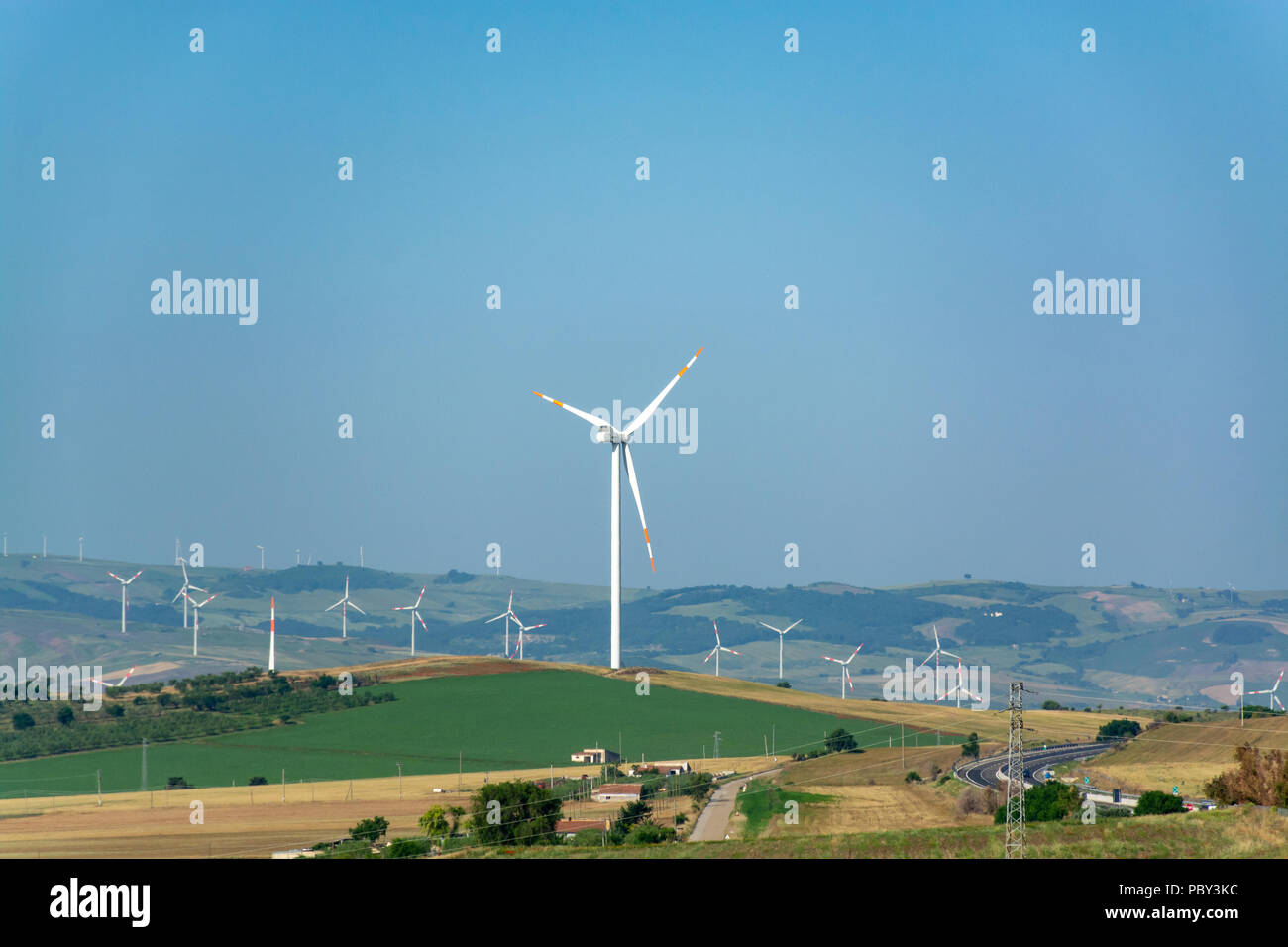 Modern wind farm with big wind turbines towers, source for renewable ...