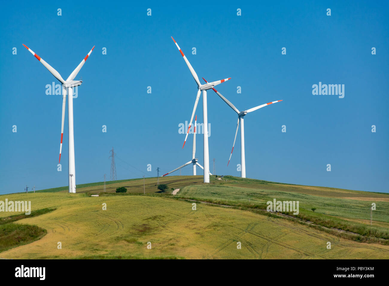 Modern wind farm with big wind turbines towers, source for renewable ...