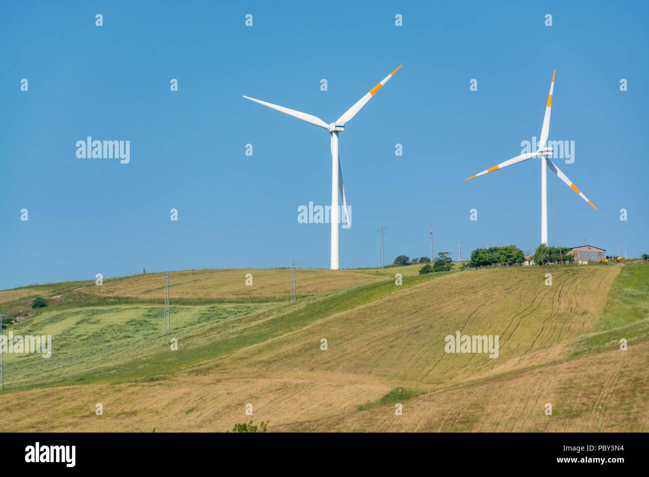 Modern wind farm with big wind turbines towers, source for renewable ...