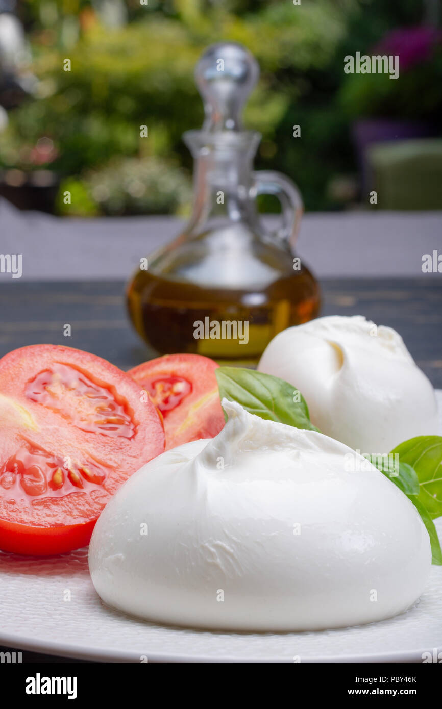 Fresh soft white burrata, ball buttery cheese, made from a mix of ...