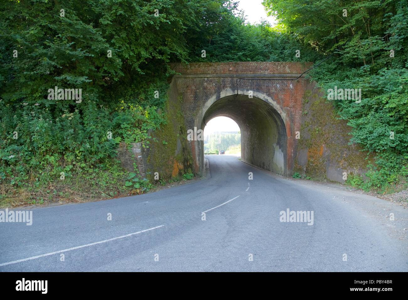 Railway bridge: a disused brick-built railway bridge allows a road to ...