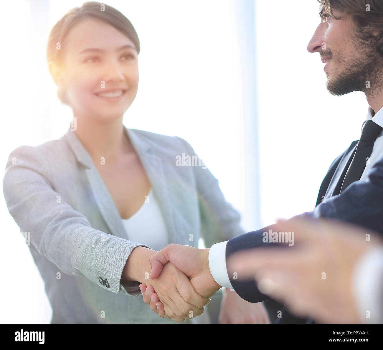 handshake business partners for their Desk Stock Photo - Alamy