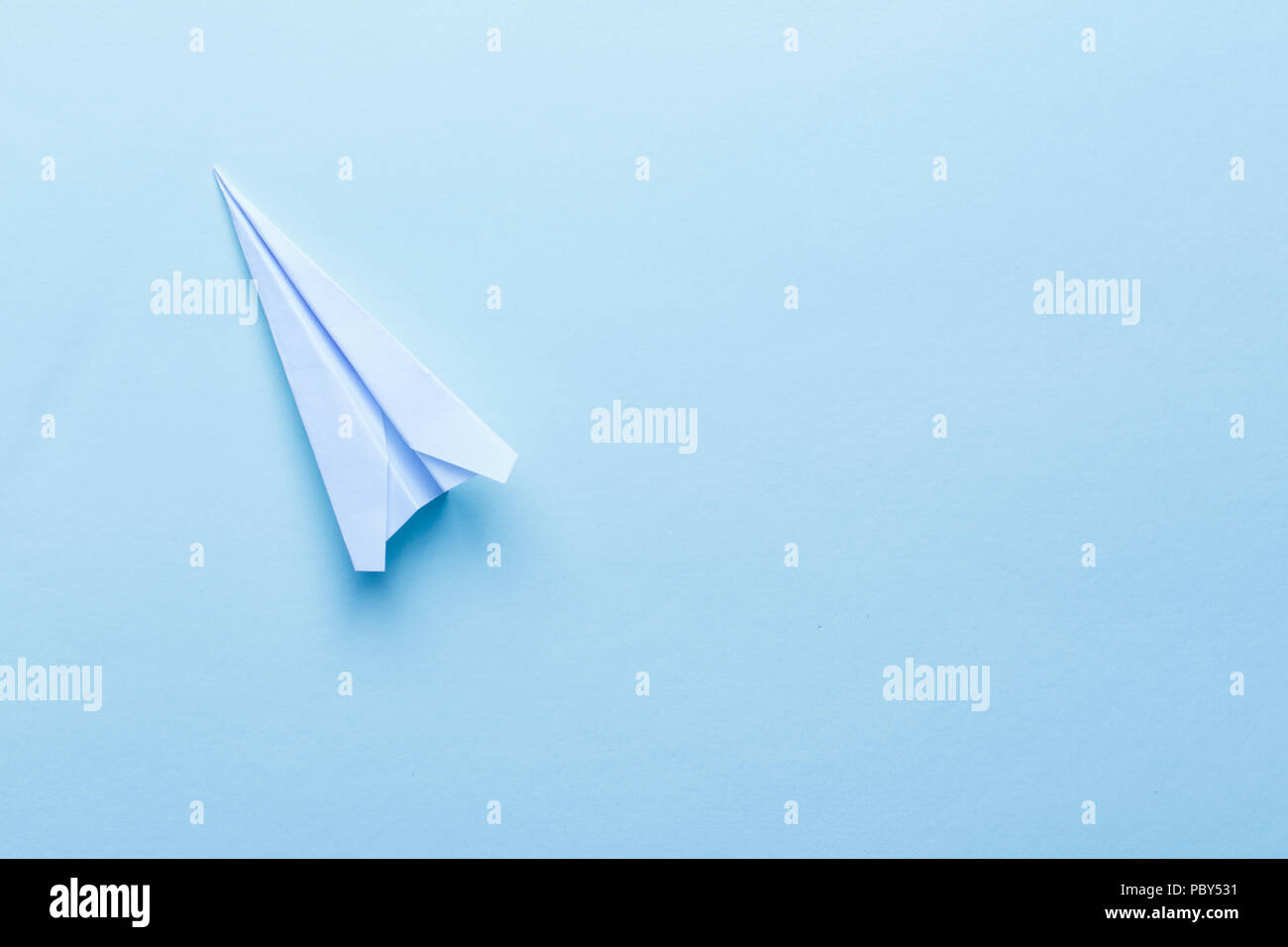Paper airplane on light blue background Stock Photo - Alamy