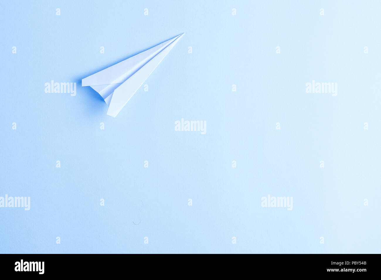 Paper airplane on light blue background Stock Photo - Alamy