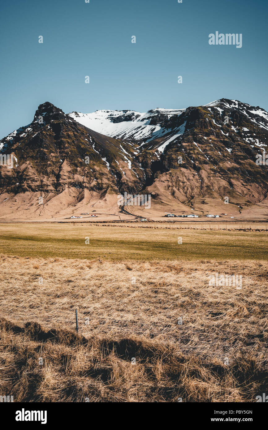 Iceland typical mountain winter scene with grass in foreground and ...