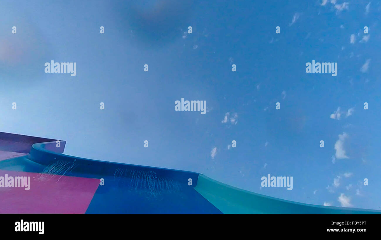 Water color attraction slide with water splashes in an outdoor water ...