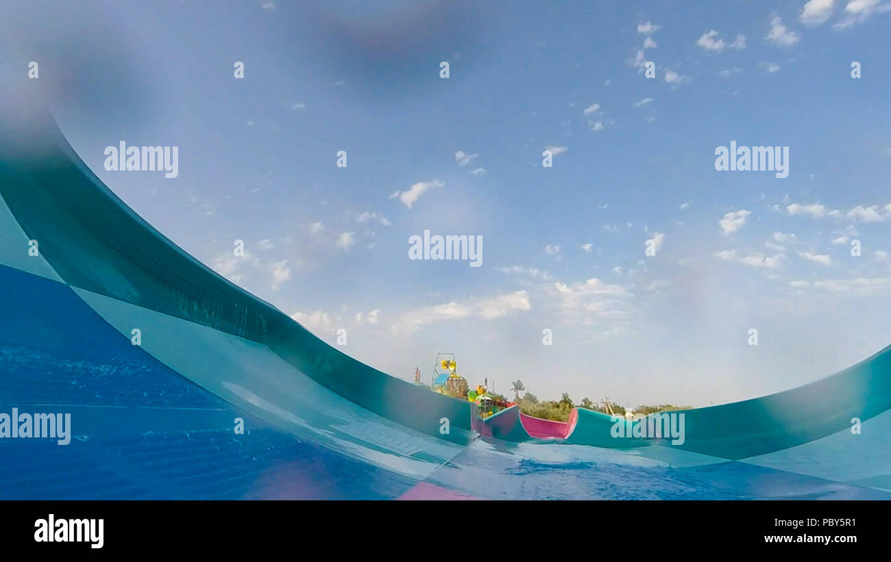 Water color attraction slide with water splashes in an outdoor water ...