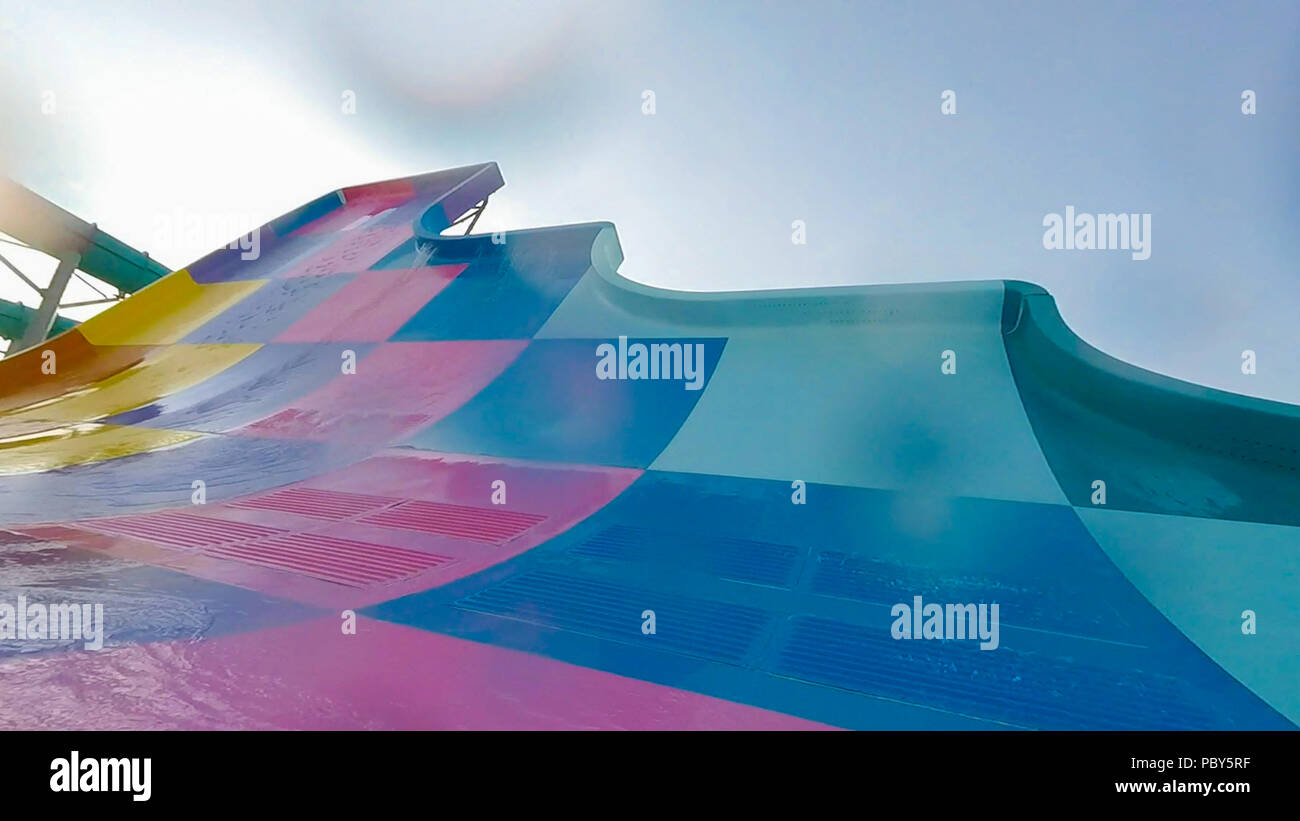 Water color attraction slide with water splashes in an outdoor water ...