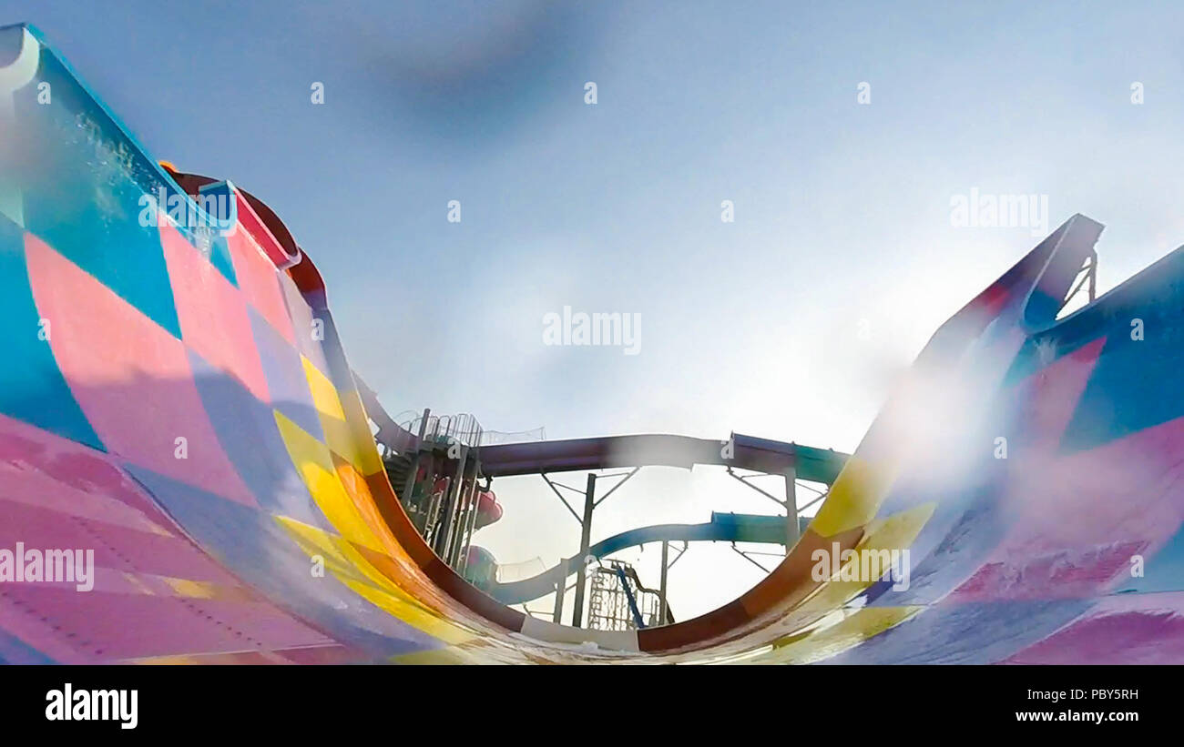 Water color attraction slide with water splashes in an outdoor water ...