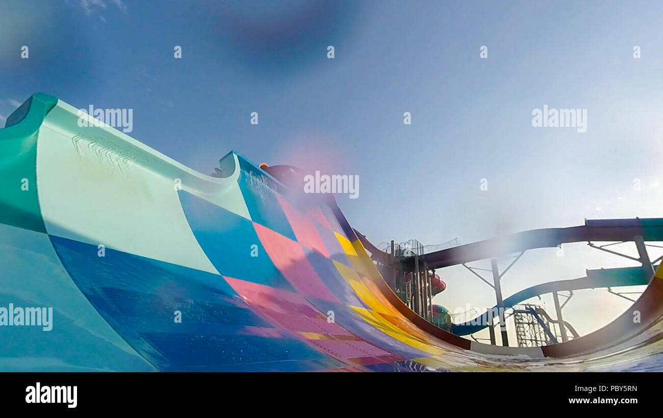 Water color attraction slide with water splashes in an outdoor water ...