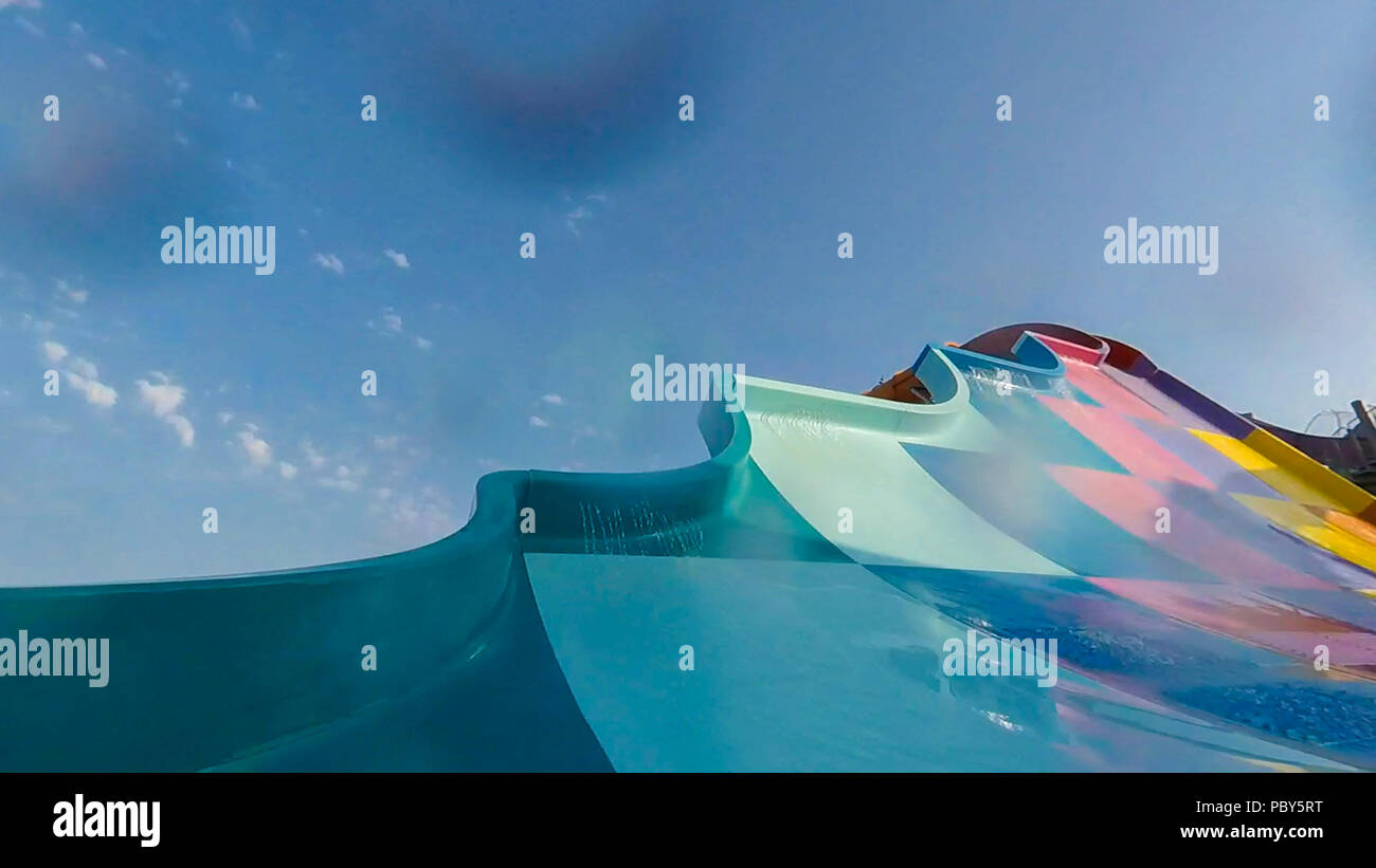 Water color attraction slide with water splashes in an outdoor water ...