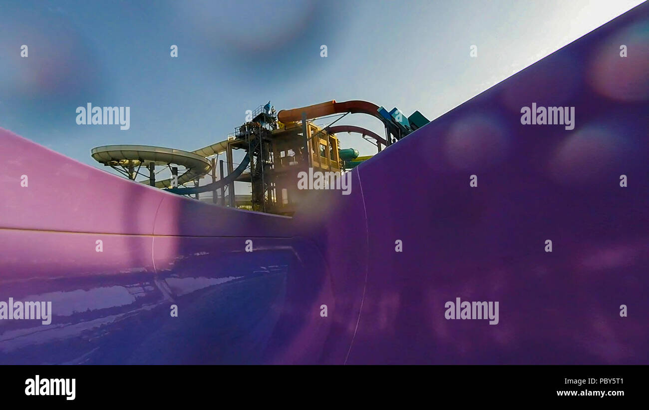 Water color attraction slide with water splashes in an outdoor water ...