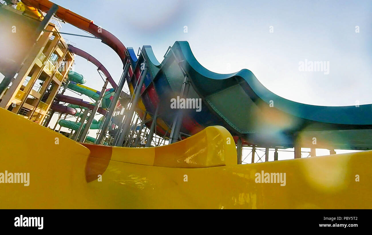 Water color attraction slide with water splashes in an outdoor water ...