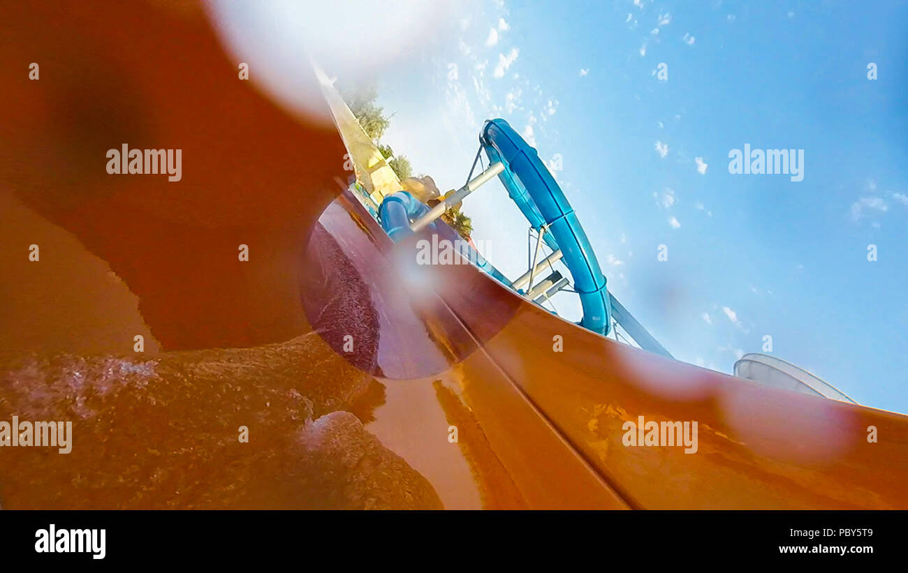 Water color attraction slide with water splashes in an outdoor water ...