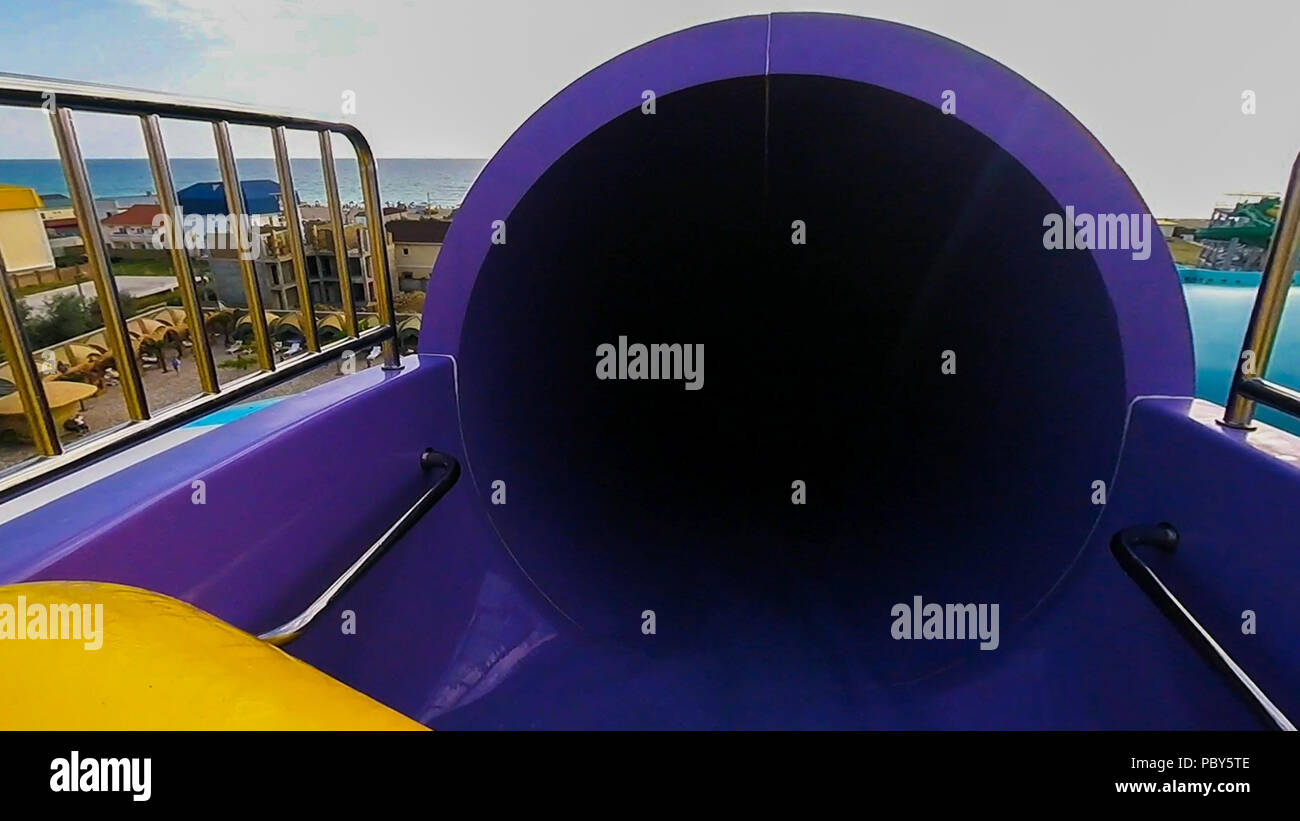 Water color attraction slide with water splashes in an outdoor water ...
