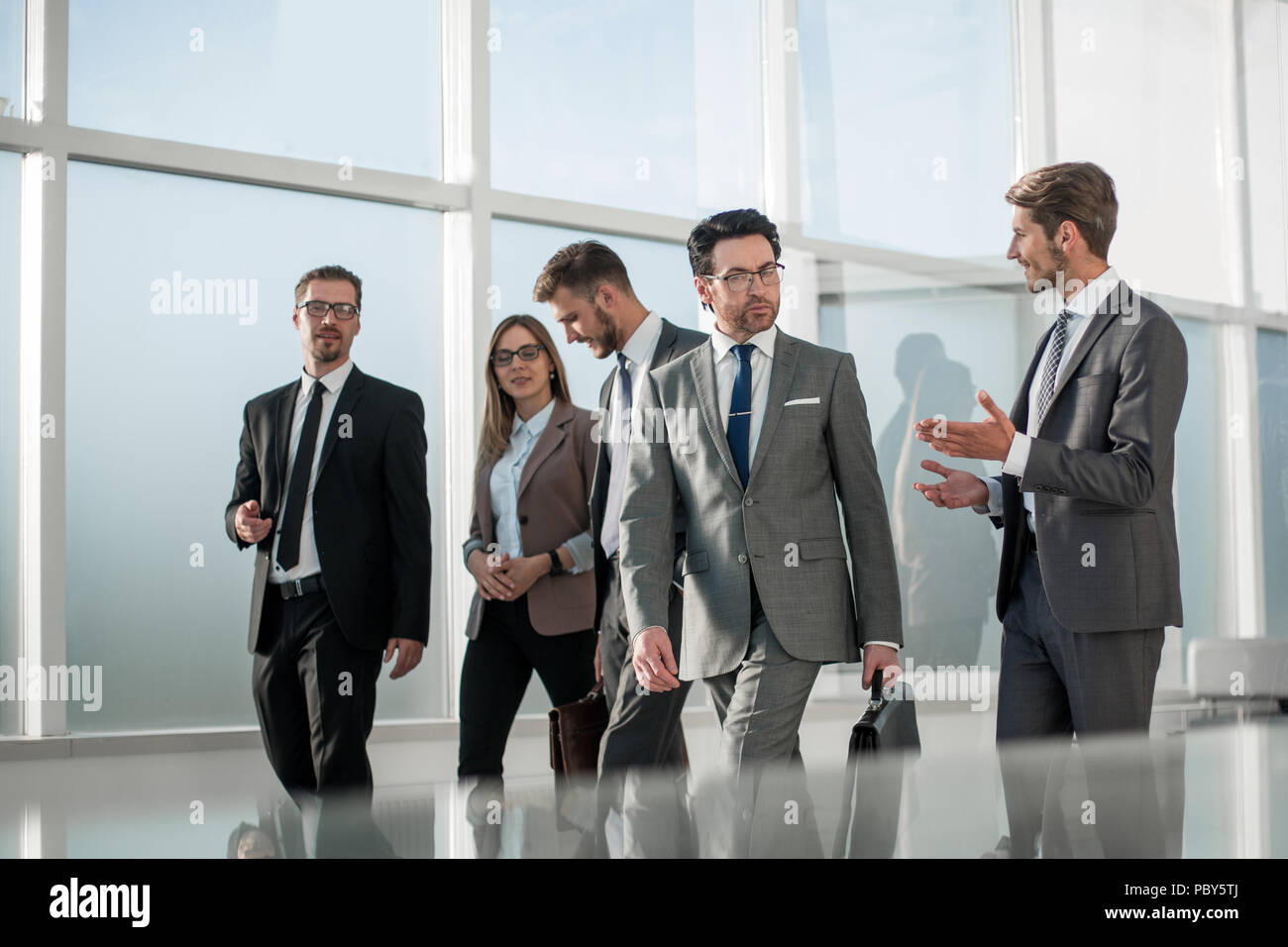 students with a teacher move forward in the foyer Stock Photo - Alamy