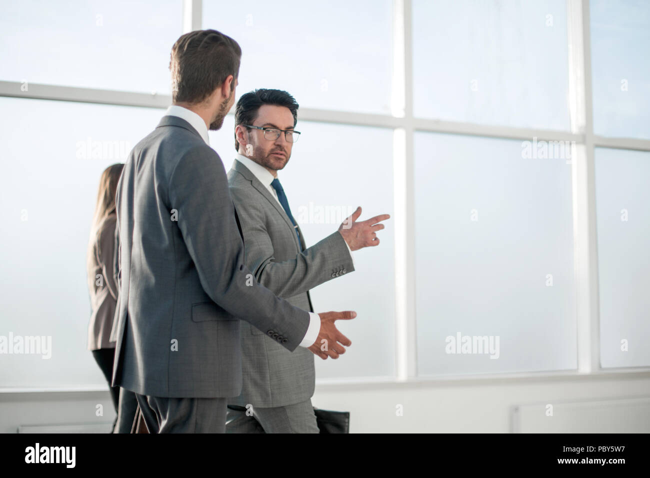 students with a teacher move forward in the foyer Stock Photo - Alamy