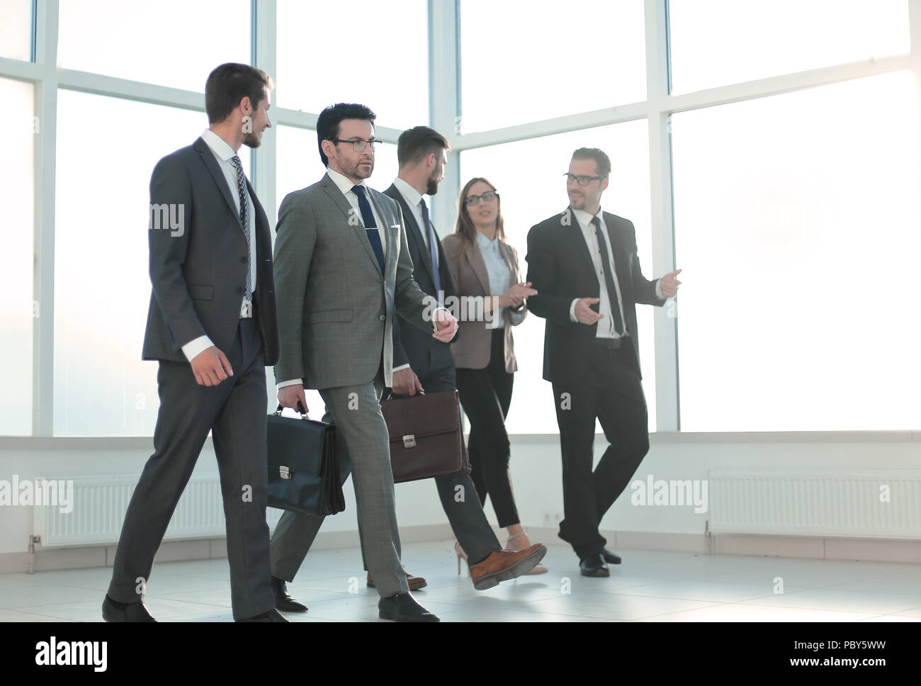 Businesspeople walking in the office background Stock Photo - Alamy