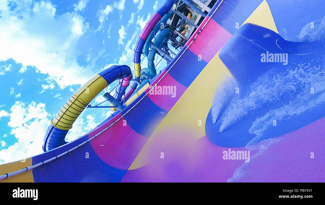 Water color attraction slide with water splashes in an outdoor water ...