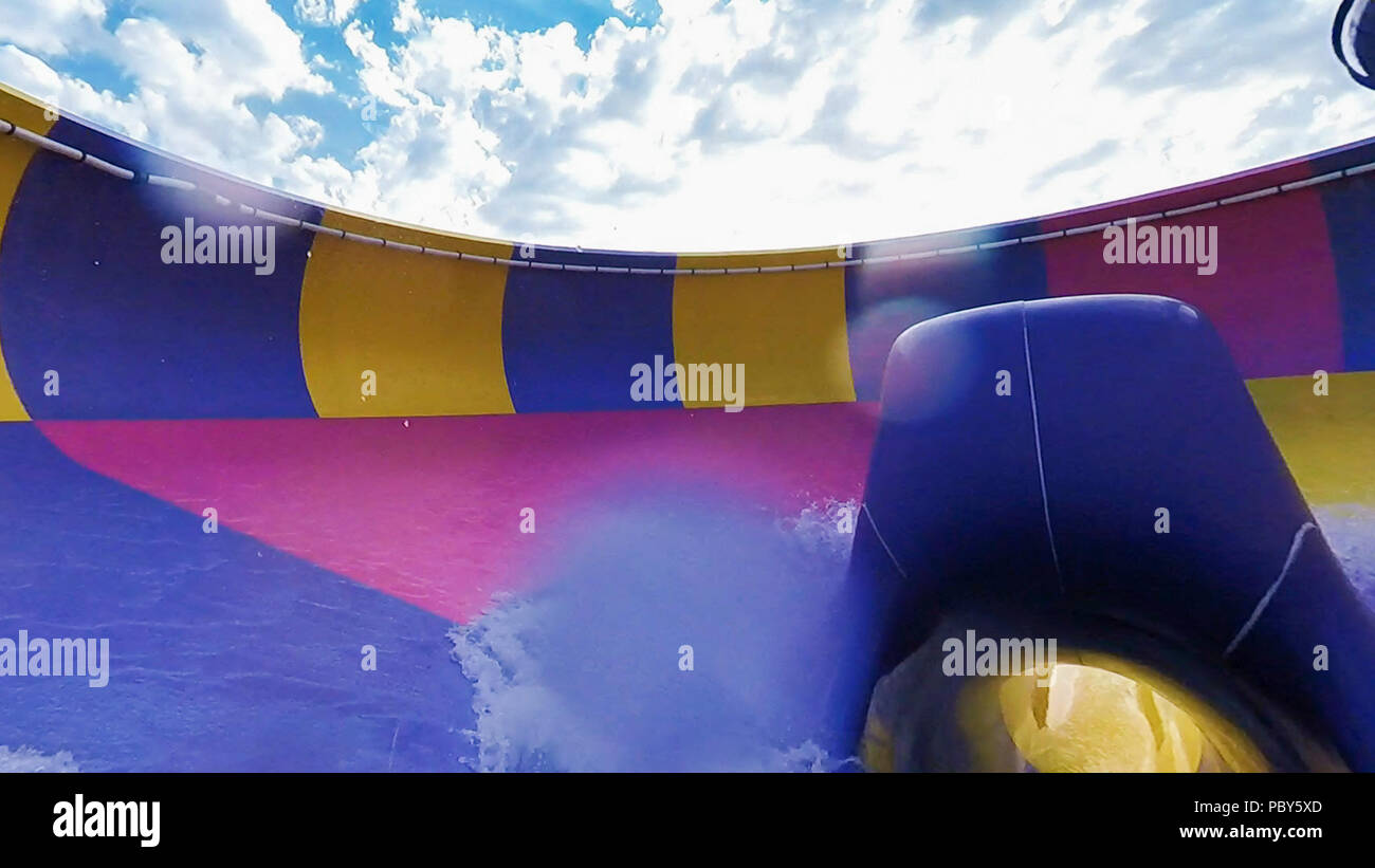 Water color attraction slide with water splashes in an outdoor water ...
