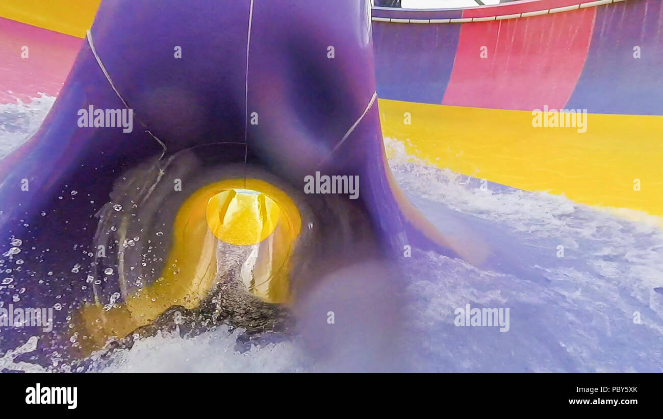 Water color attraction slide with water splashes in an outdoor water ...