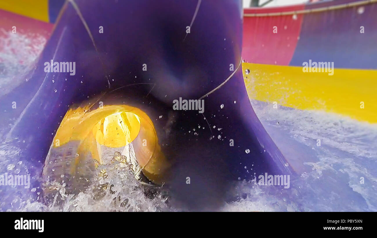 Water color attraction slide with water splashes in an outdoor water ...