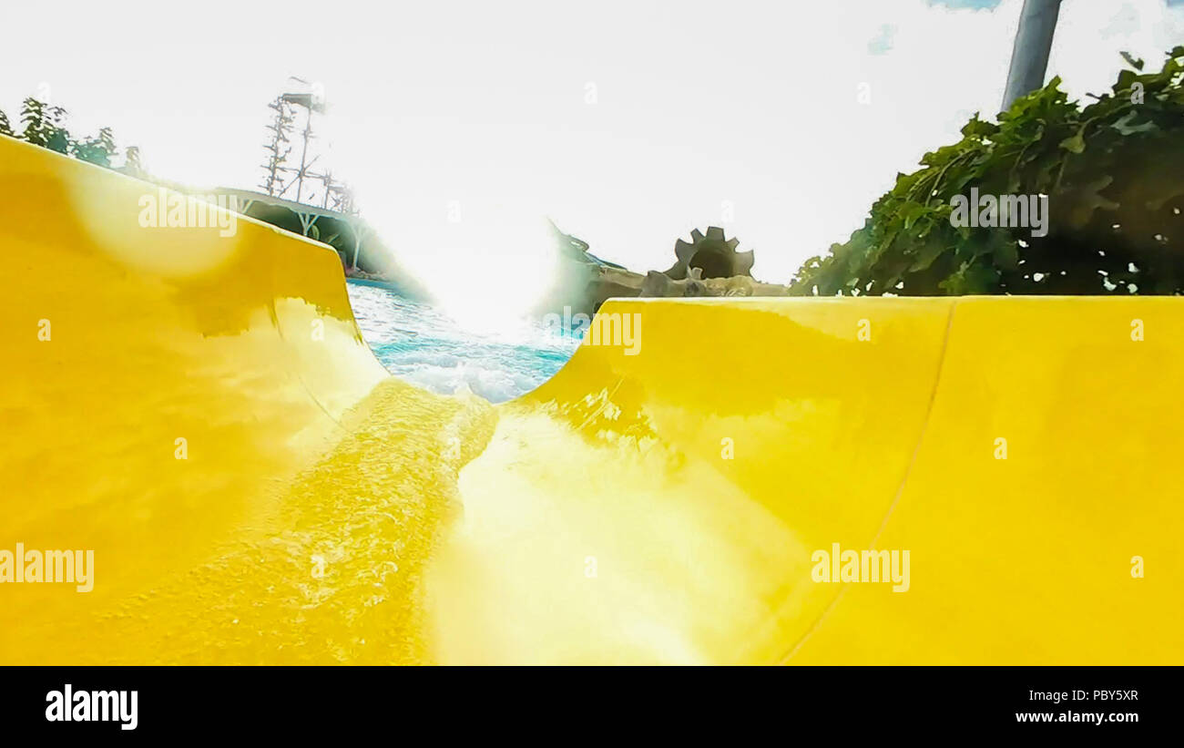 Water color attraction slide with water splashes in an outdoor water ...