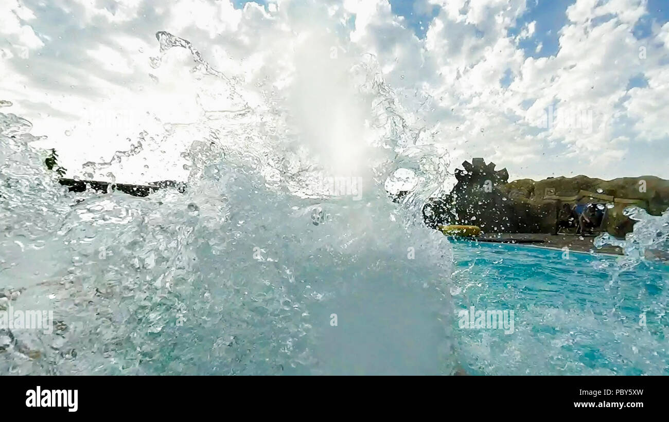 Water splash in the pool after the departure from the water attraction ...