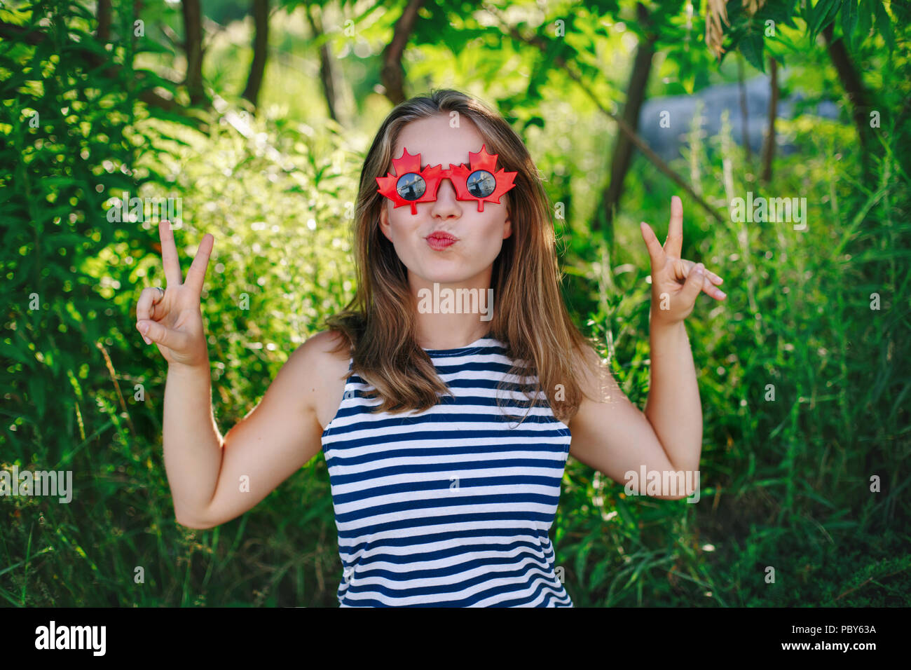 Portrait of funny beautiful white Caucasian young girl wearing canadian ...