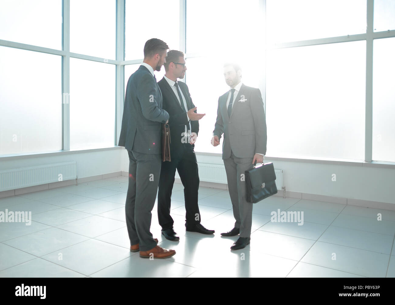 A businessman greeting clients Stock Photo - Alamy