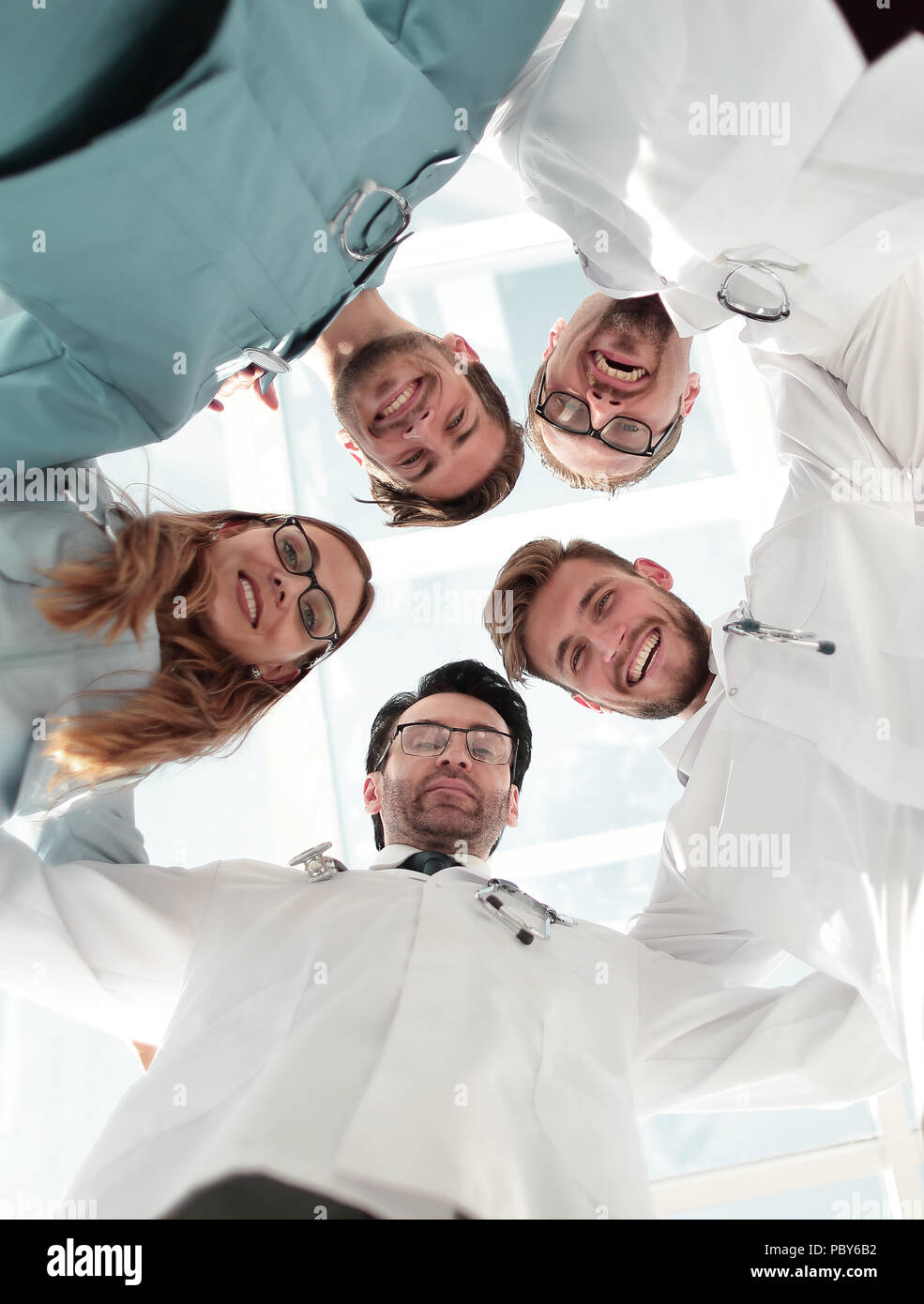 doctors looking down smiling at the camera Stock Photo - Alamy