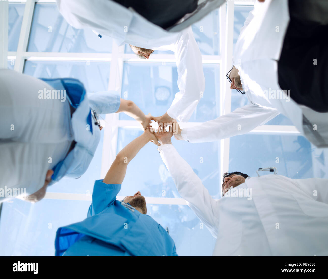 Doctors and nurses in a medical team stacking hands Stock Photo - Alamy