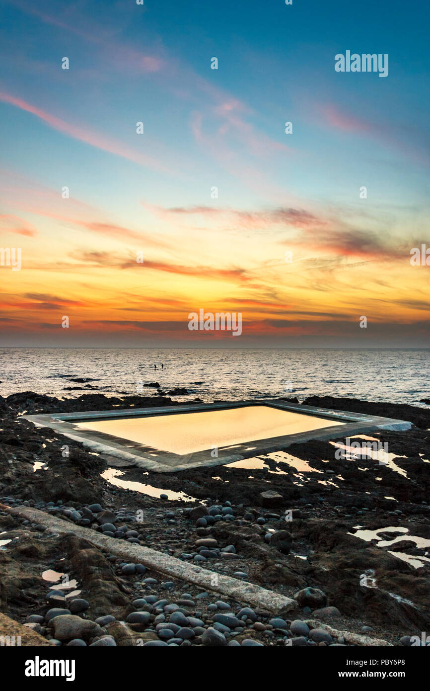 The seawater swimming pool at Westward Ho!, Devon, UK, illuminated by ...