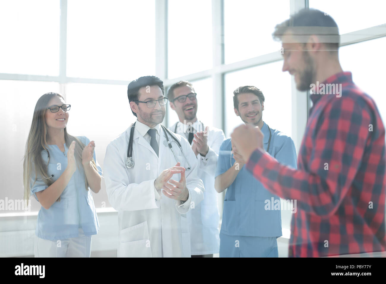 medical doctor shaking hands with patient in clinic Stock Photo - Alamy